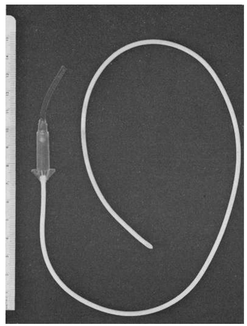 Fic. 3. photograph of denver hydrocephalus shunt with scale