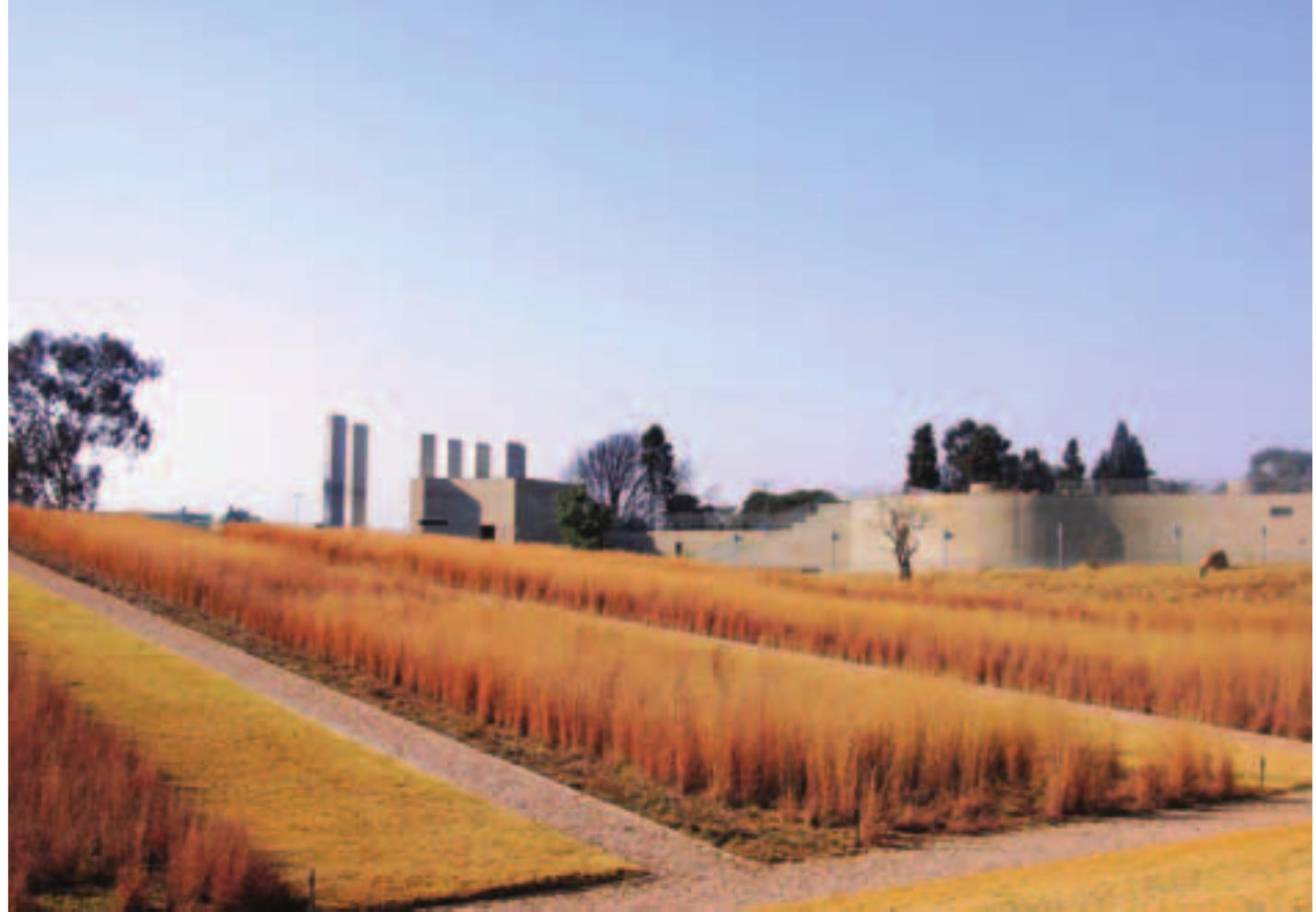 Exterior view with curved walls and planted indigenous