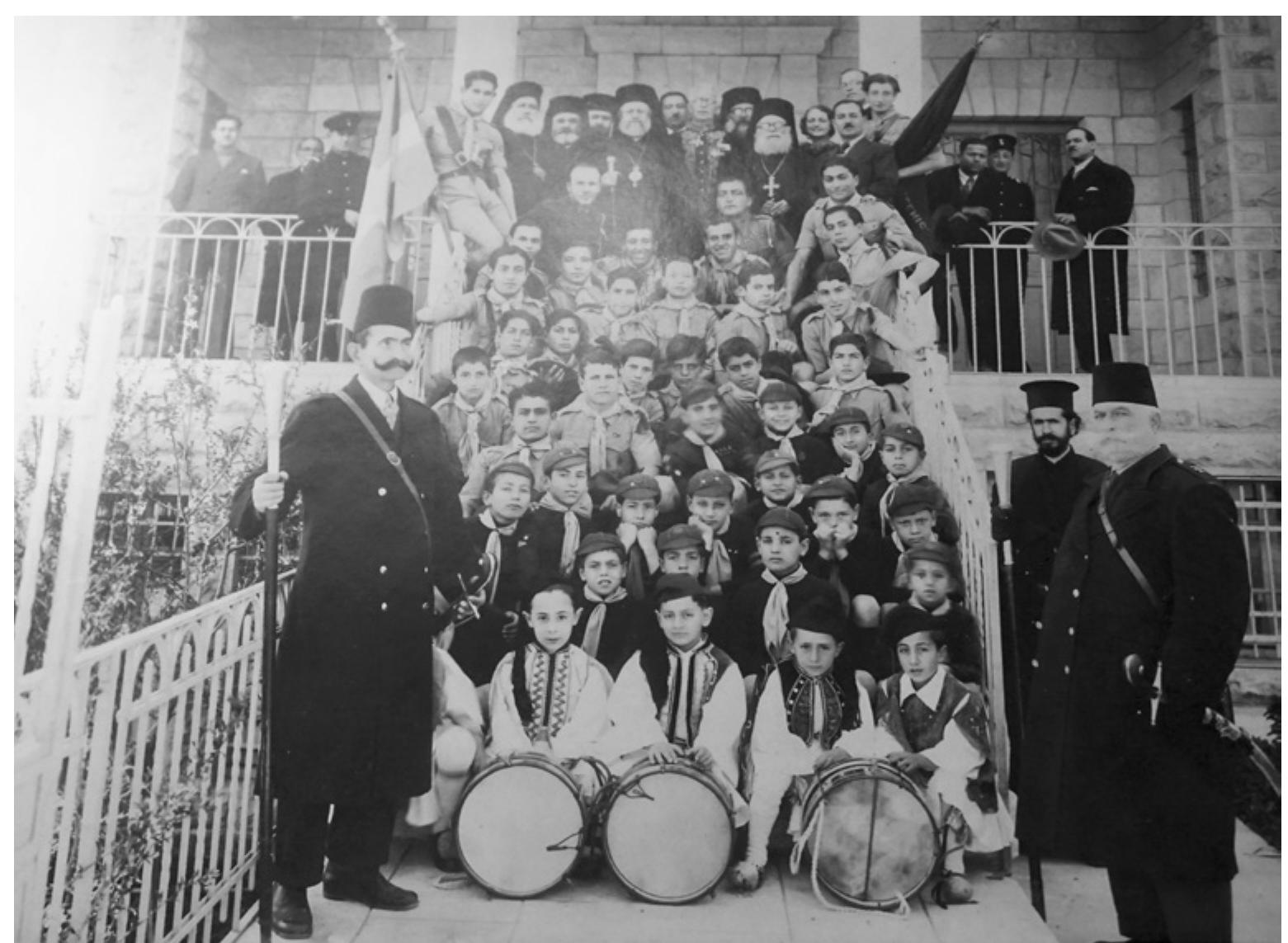 2 greek boys in scout, cub and band uniforms with patriarch