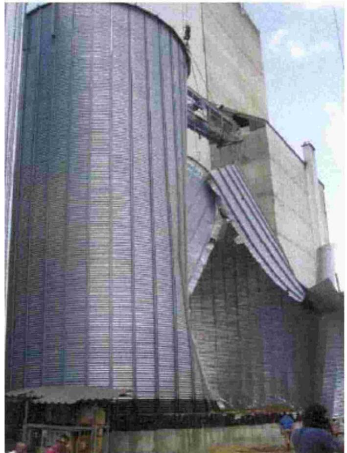 "ig. 3. burst silo had fallen onto adjacent silo on left