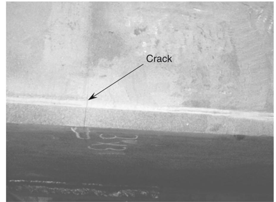 Fatigue crack emanating from the bottom flange and moving