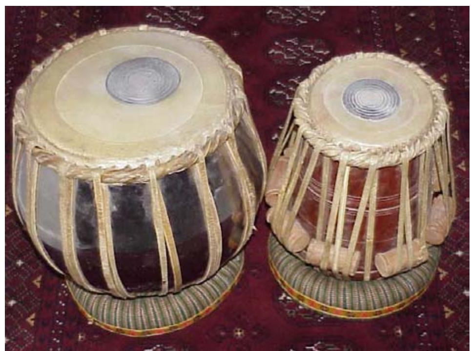 Picture showing north indian tabla. the bayan is the silver