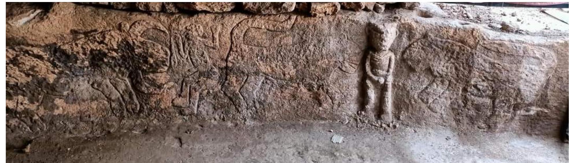 Depicts a prominent limestone bench relief featuring