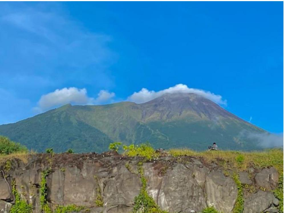 Appearance of the tugurara escarpment with mount gamalama in