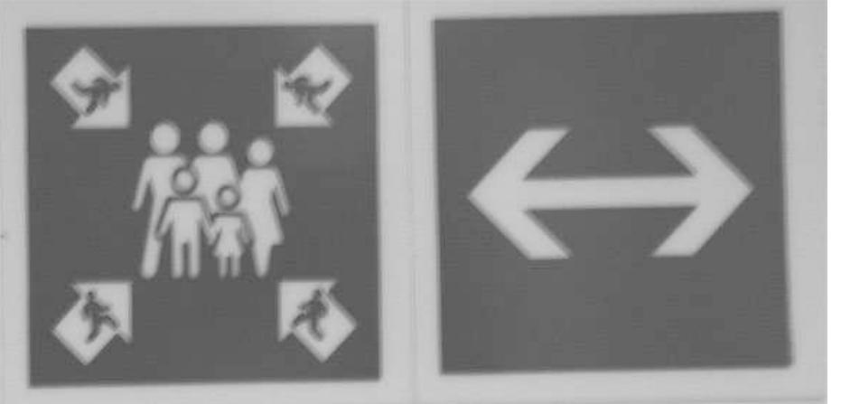 Muster sign with adjoining double arrows from the cabin area
