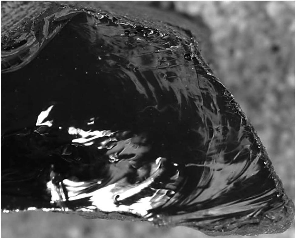 Black glassy tapped slag with a characteristic conchoidal