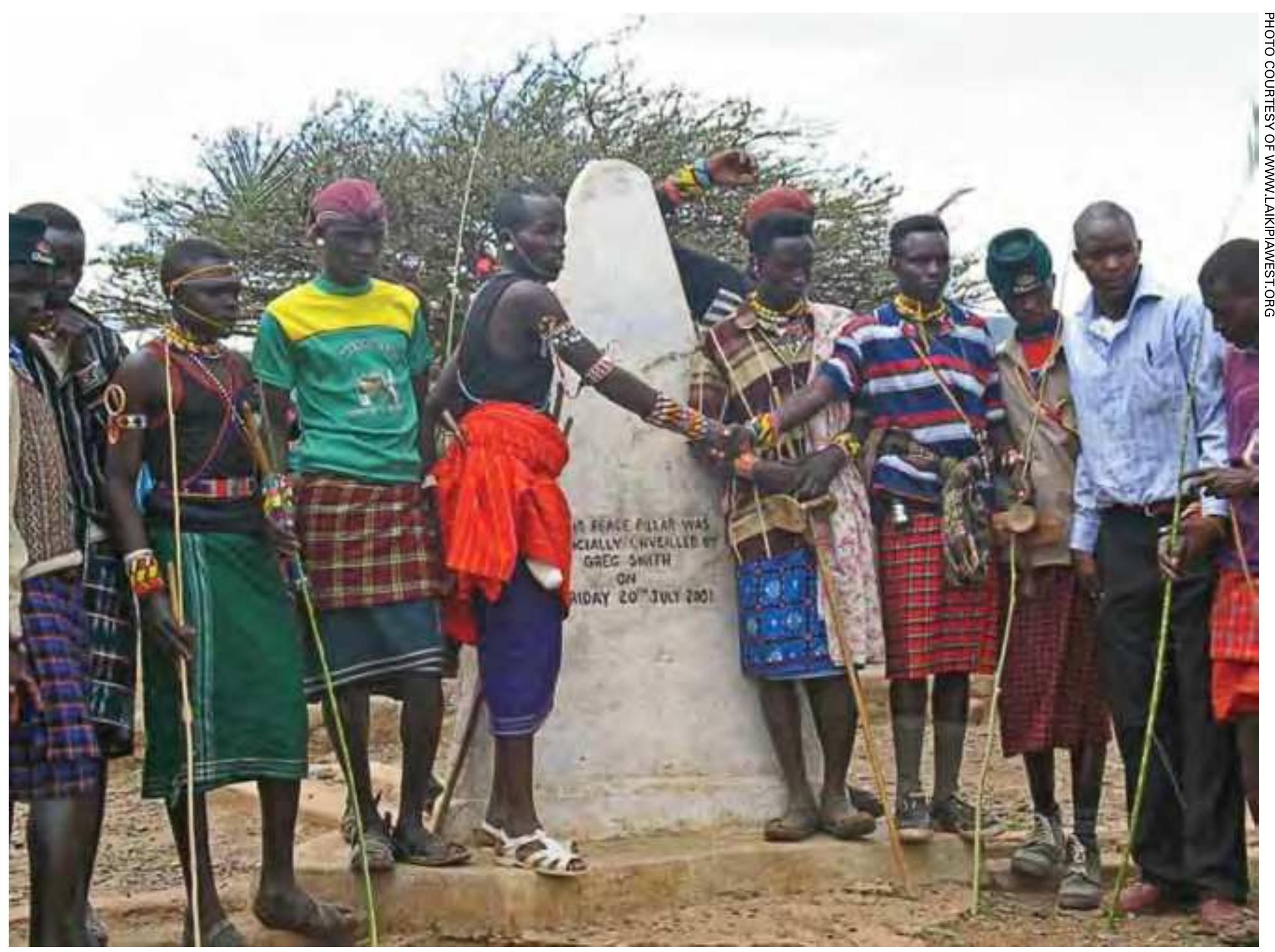 Pokot and samburu morans symbolically shake hands at the