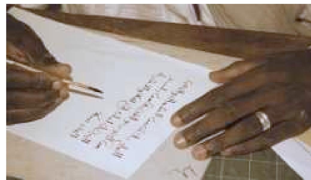 Boubar sadeck, timbuktu calligrapher, writing with a reed