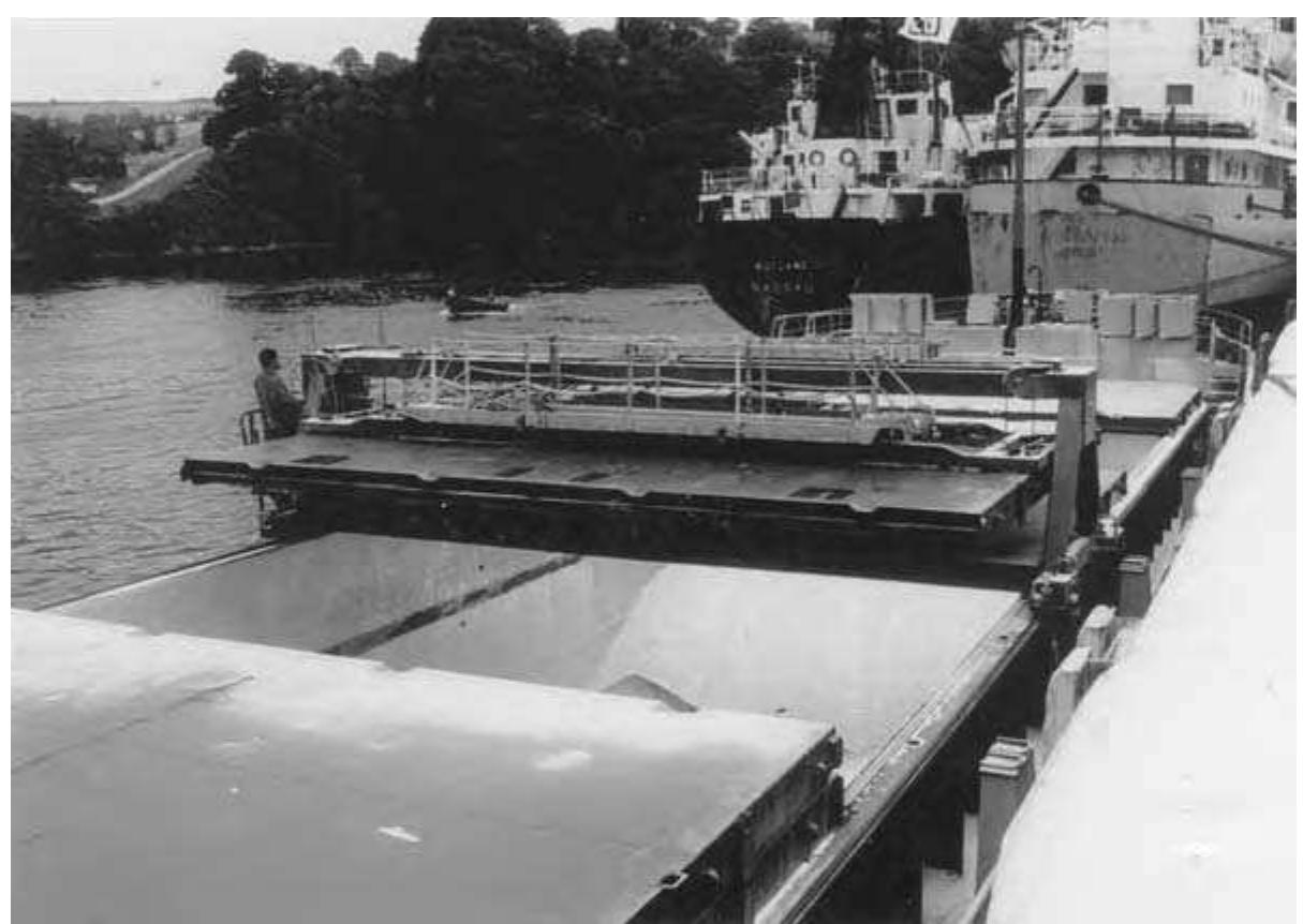 16 a low lying tracked gantry crane operates down the hatch