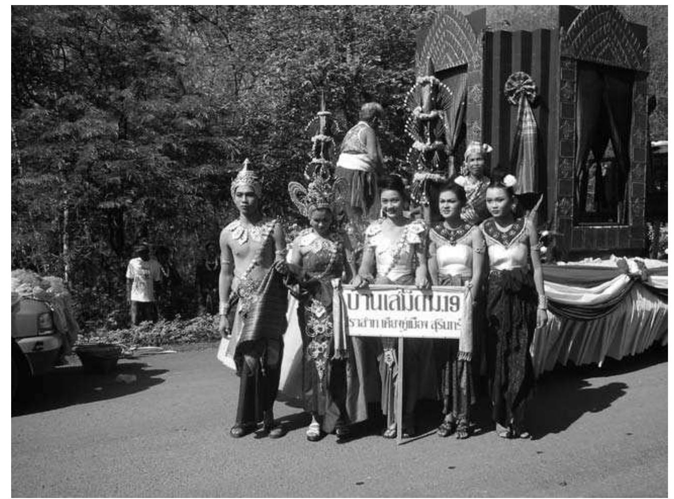 2 ethnic khmer posed in front of an ancient khmer sanctuary