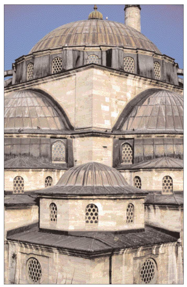 Above a main dome on a cubed structure forms the base of the