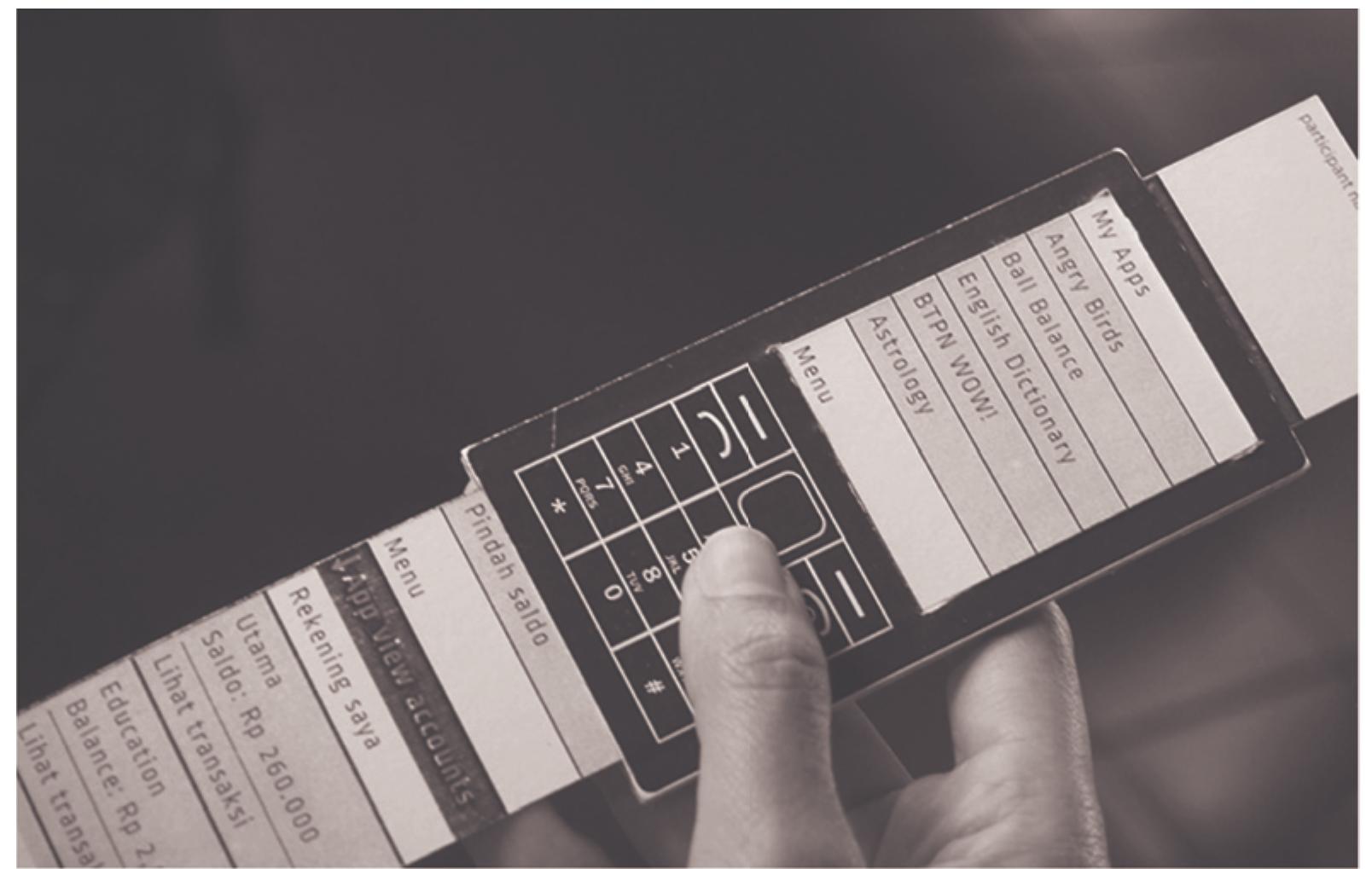 Cardboard mockup of a mobile banking prototype in indonesia