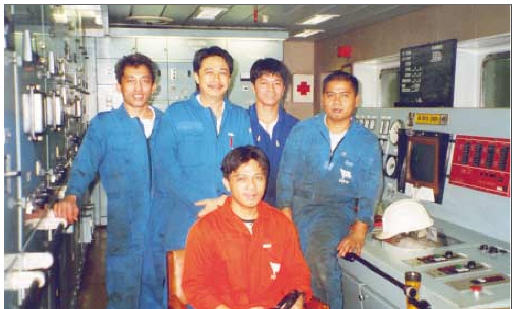 A cadet (in the middle) during his on board training.
