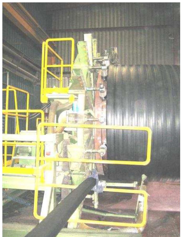 The extruded profile is wound around the mandrel and welded