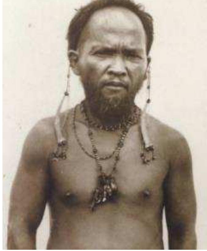 Ilongot male warrior wearing the battling and beaded neck