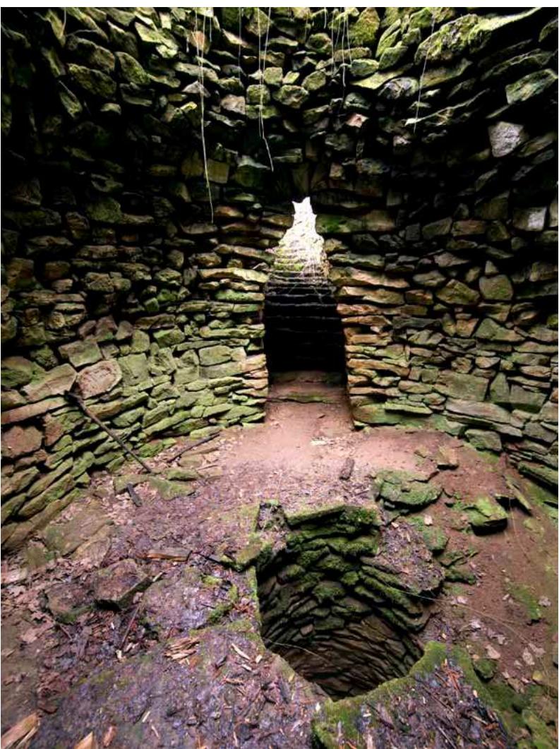 In the centre of the vault, probably equal to the diameter