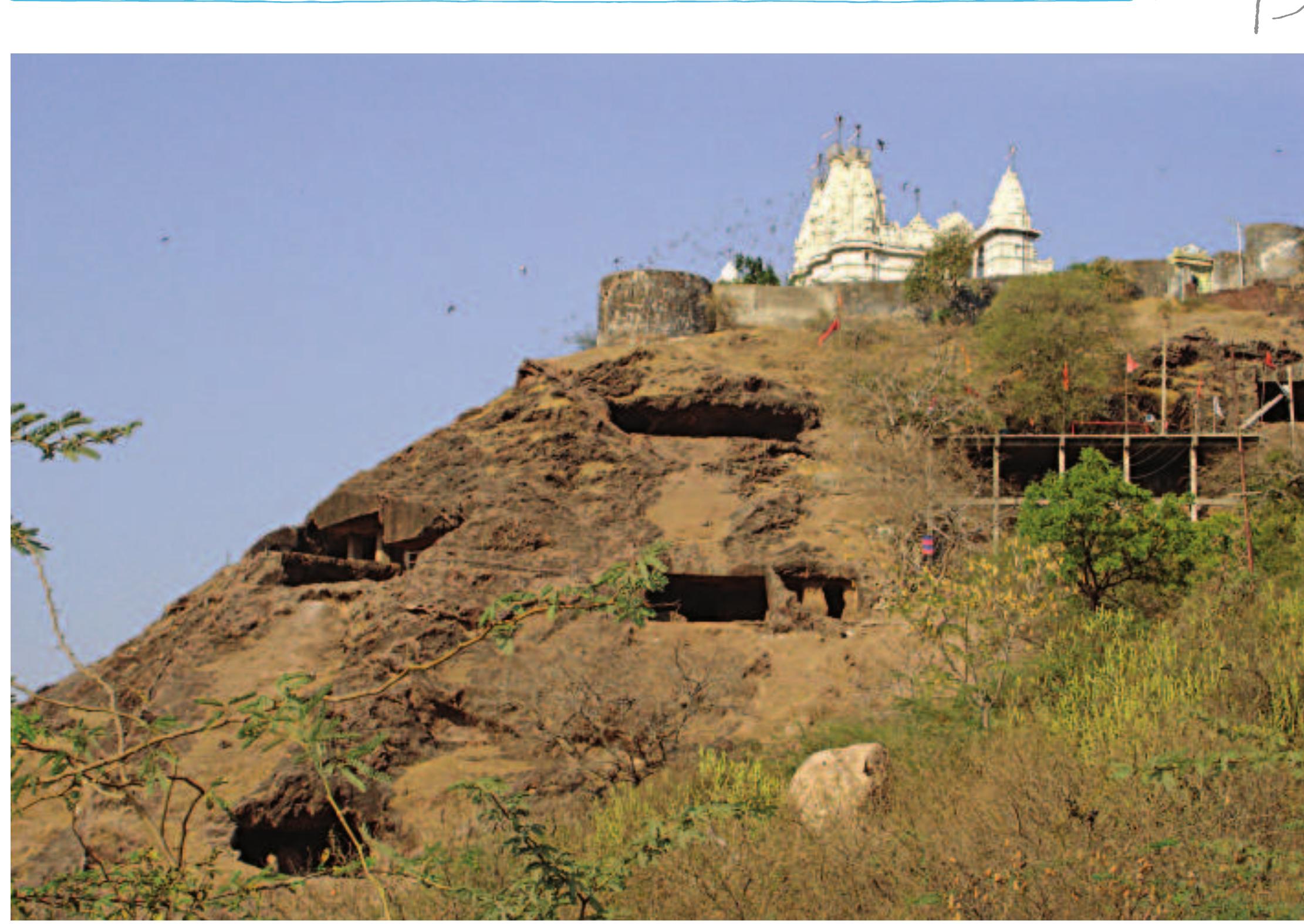 2. caves cut in the side of the hill at talaja with modern j