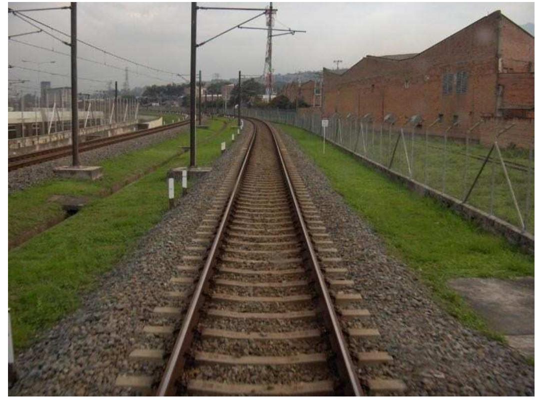 Shows an image where the rails are capture from the train