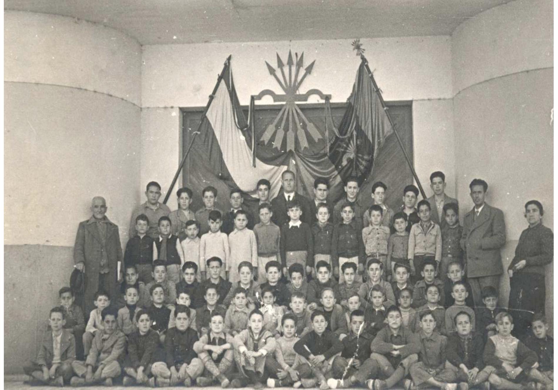 Wearing the falange movement uniform along the facade of