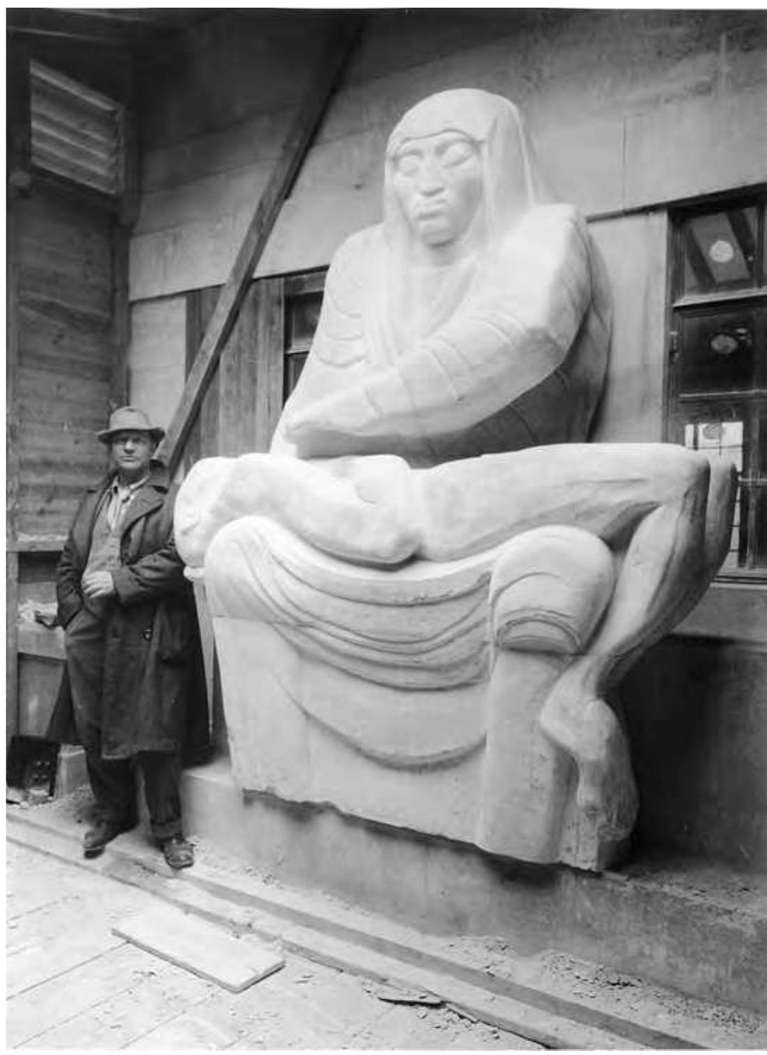 7. jacob epstein standing before his sculpture night, carved