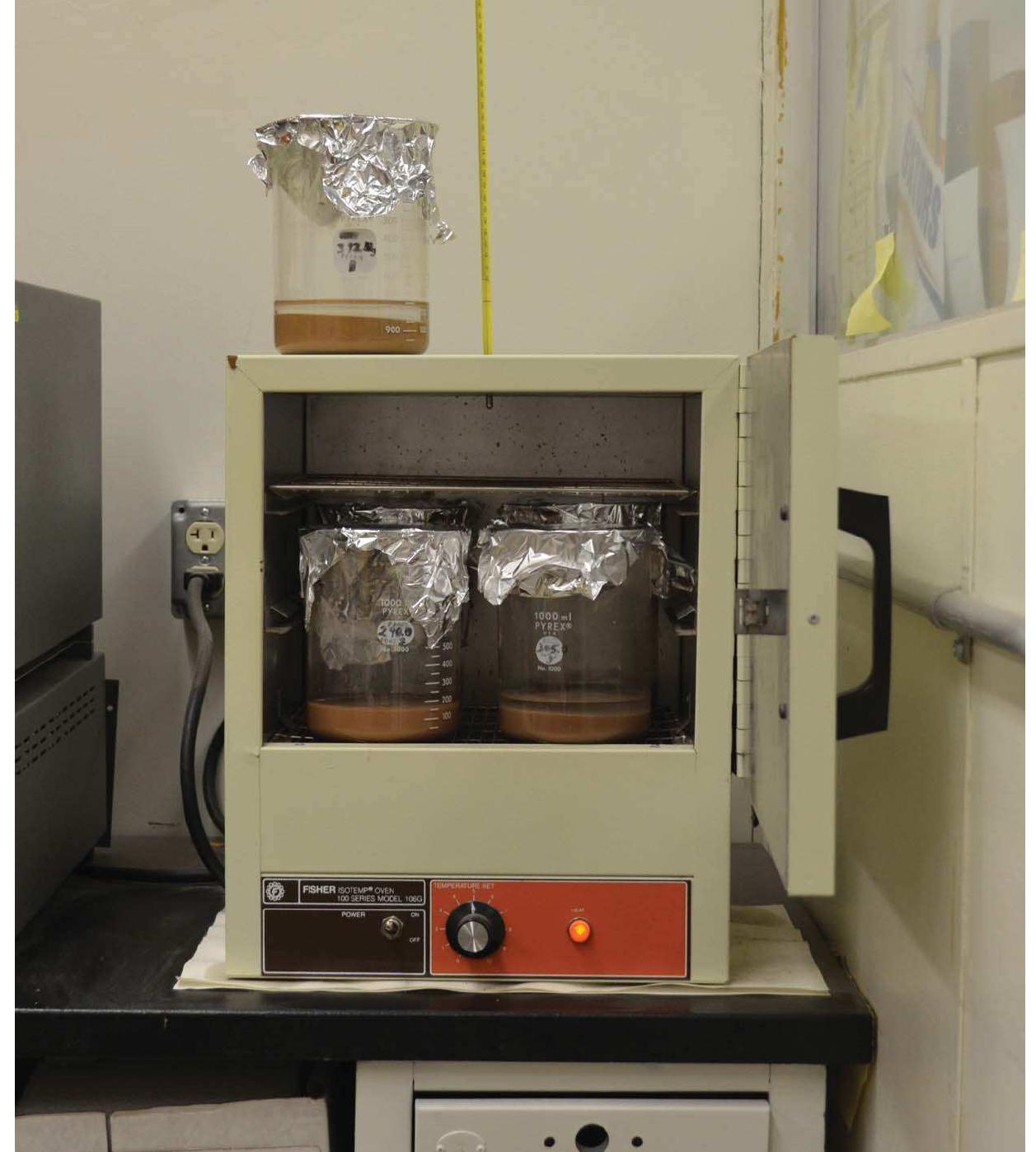 Beakers of fine fractions in drying oven (another sample,