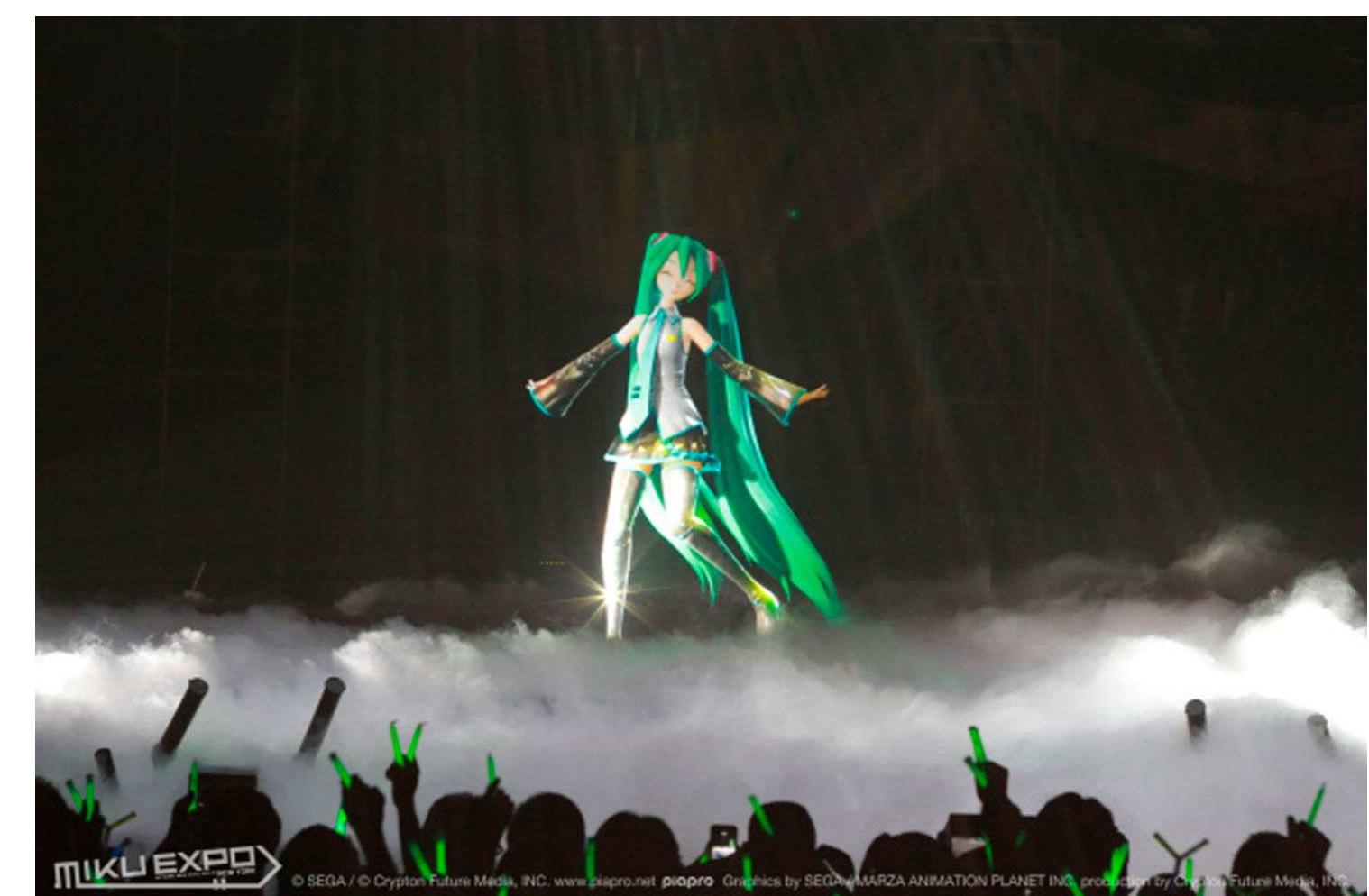 The hatsune miku hologram performing in front of fans,