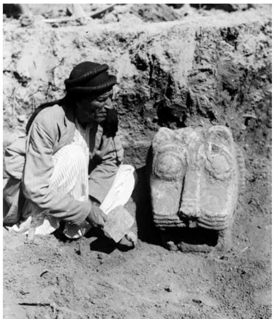 Hamoudi ibn sheikh ibrahim, woolley’s foreman, sitting next
