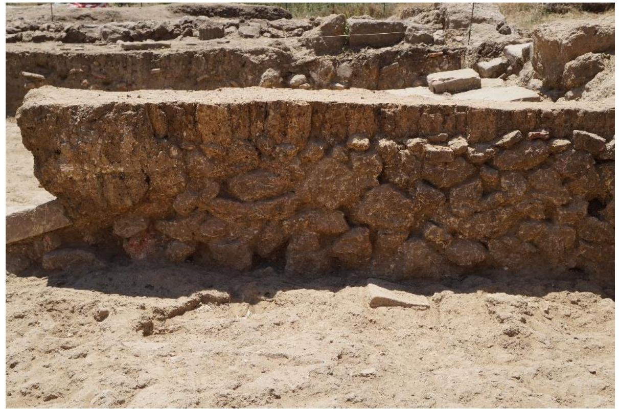 East face of wall qq showing pisé and plaster (detail).