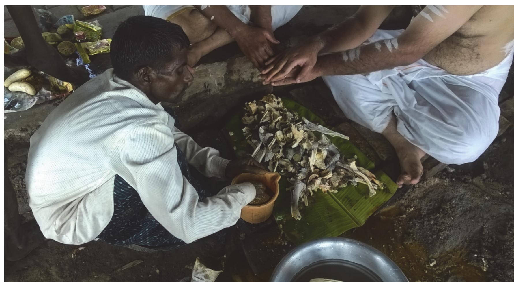 Cremated bones are washed and offerings are made