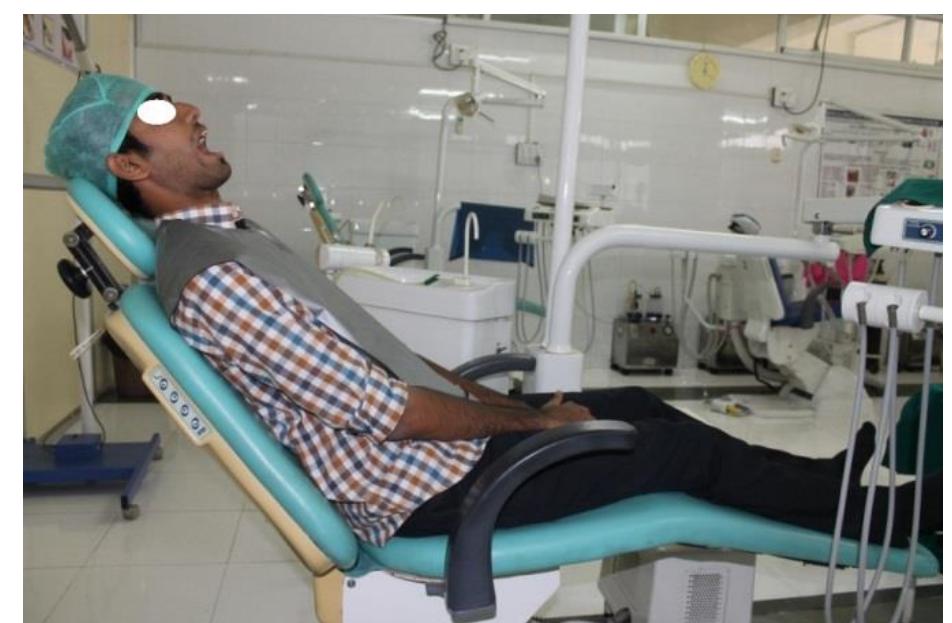 B]: chair position for maxillary extractions.