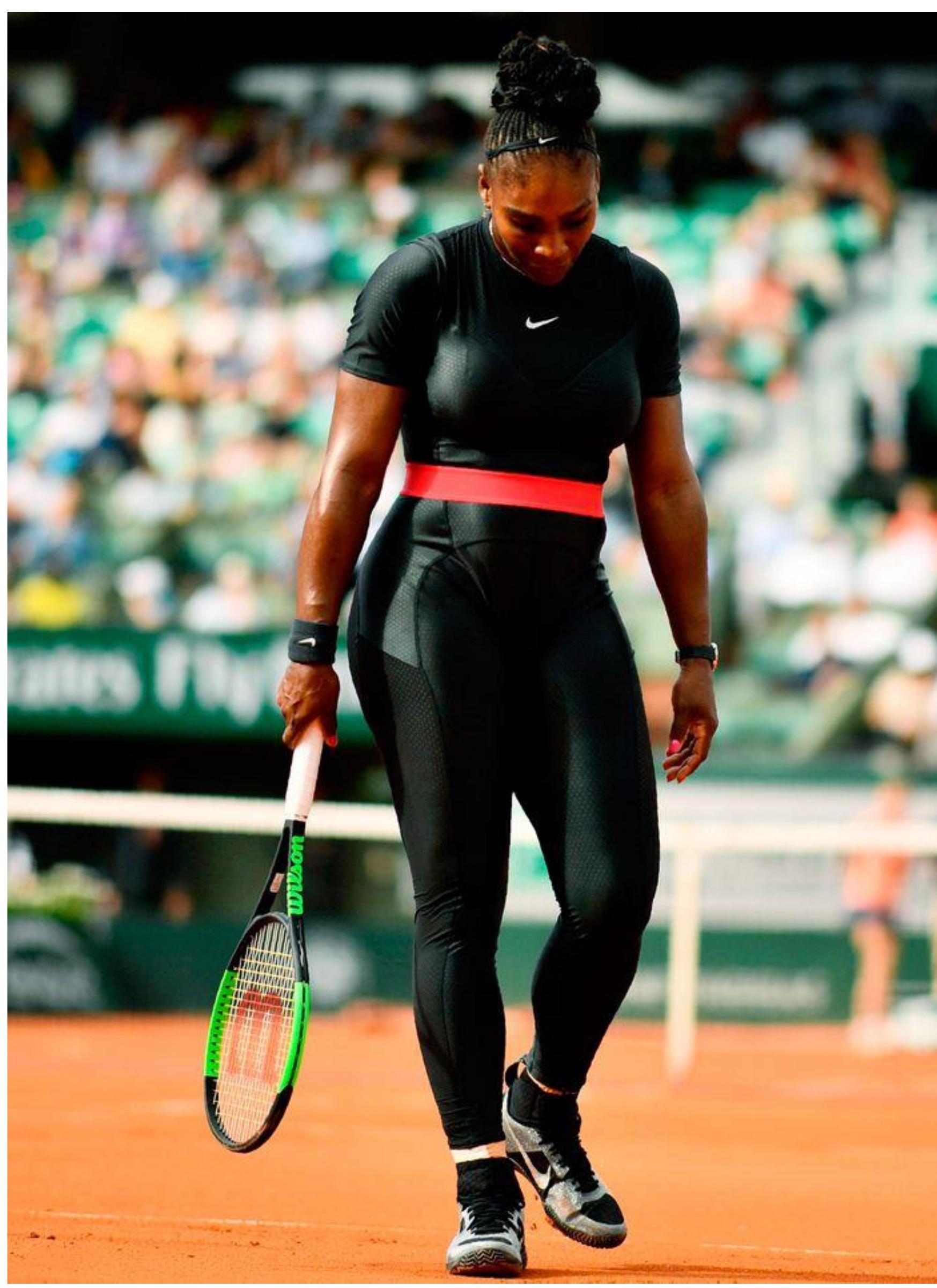 Serena williams wearing a full-body nike suit competing in