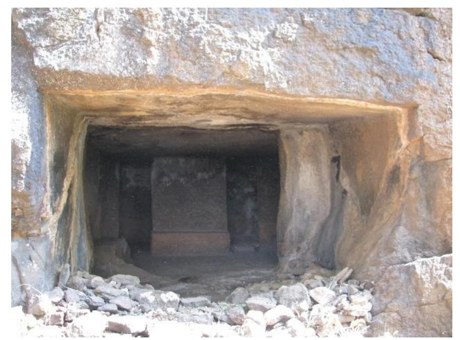 The cells of the back wall have benches. the cells on the