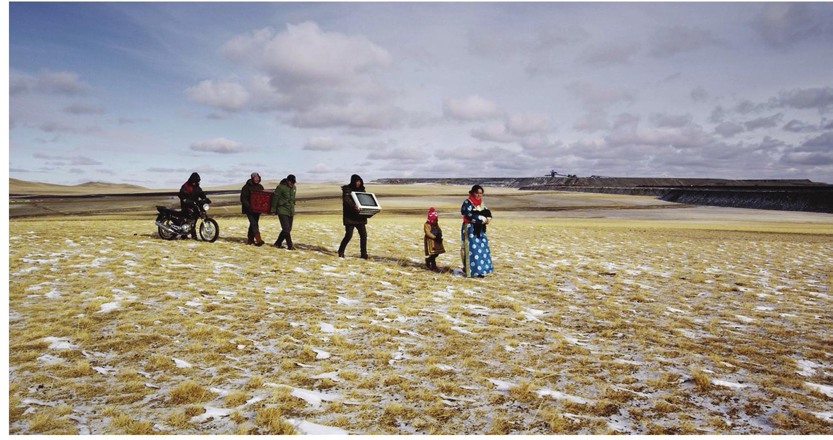 An inner mongolian family walking single-file with their