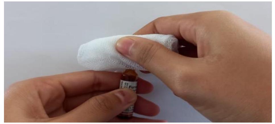 Steps to open the ampoule with gauze is 1) hold the ampoule;