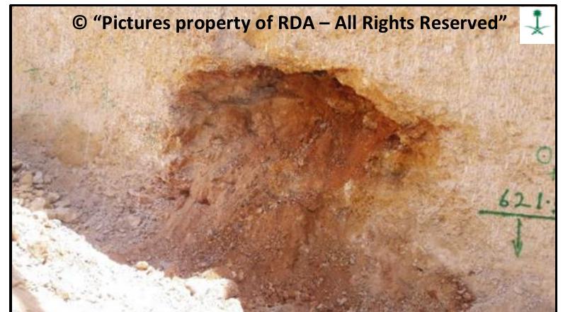 Infilled cavity exposing alluvial/ aeolian soil (4m width).
