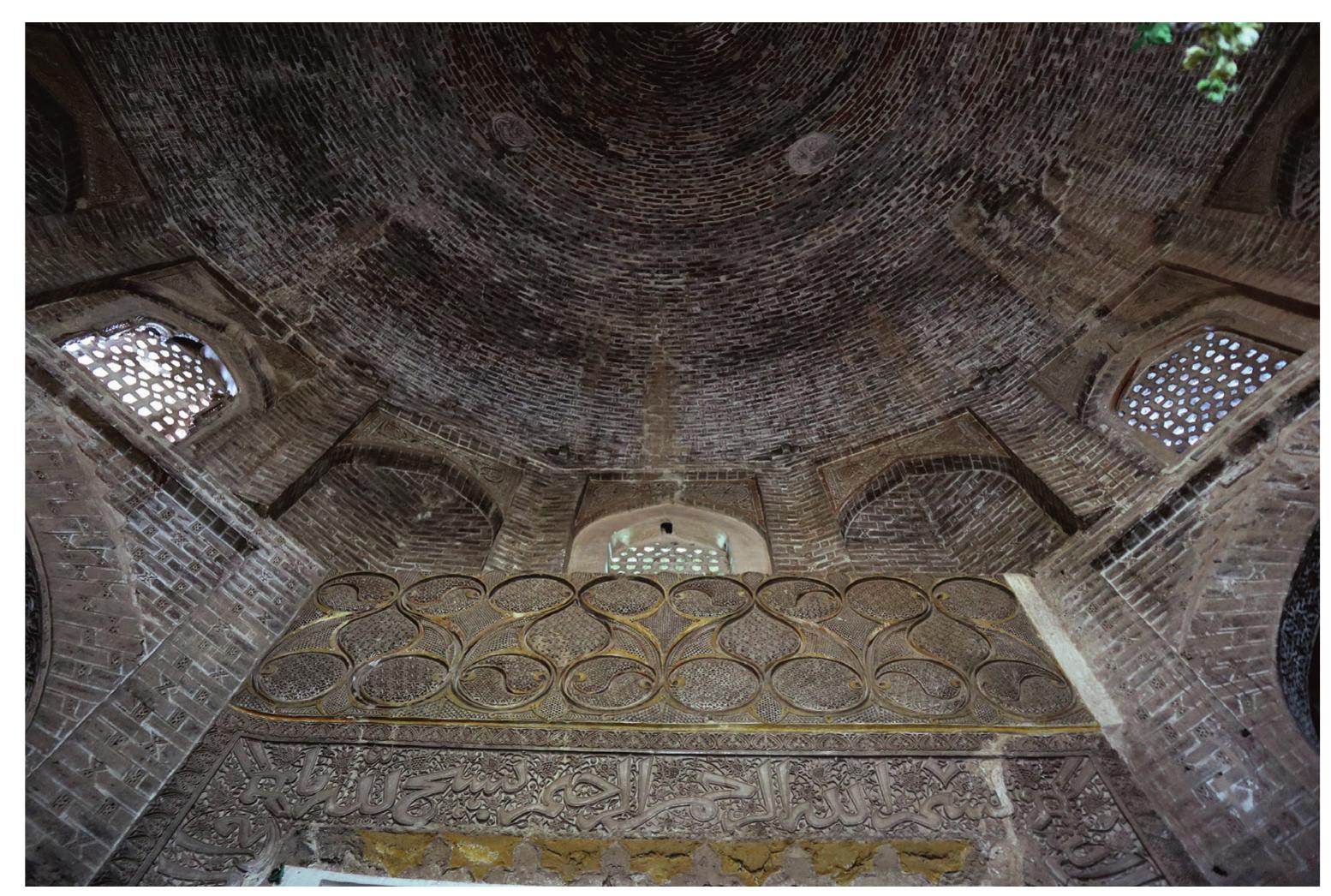 Looking up to the squat plain dome, its 16-sided zone of