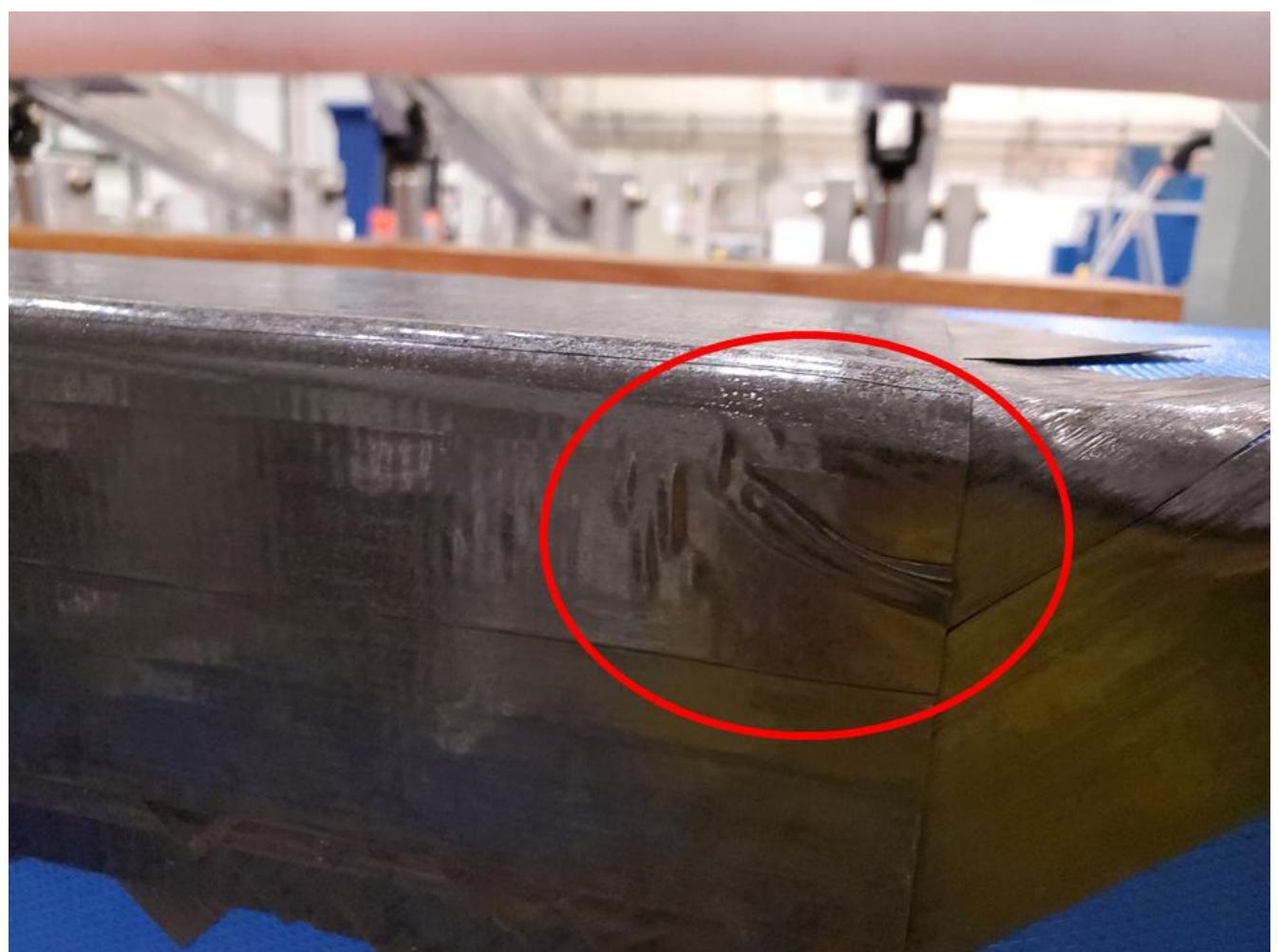 Wrinkles appear on an uncured composite laminate one