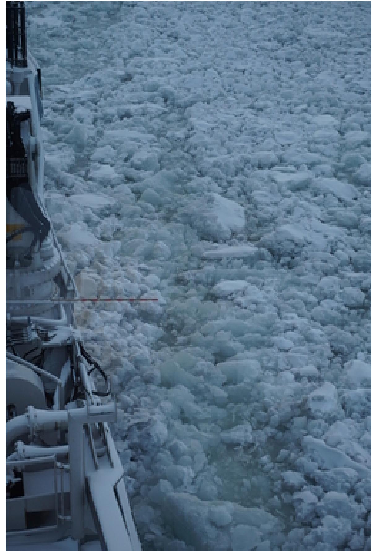 Vessel in brash ice side view in arctic routes of