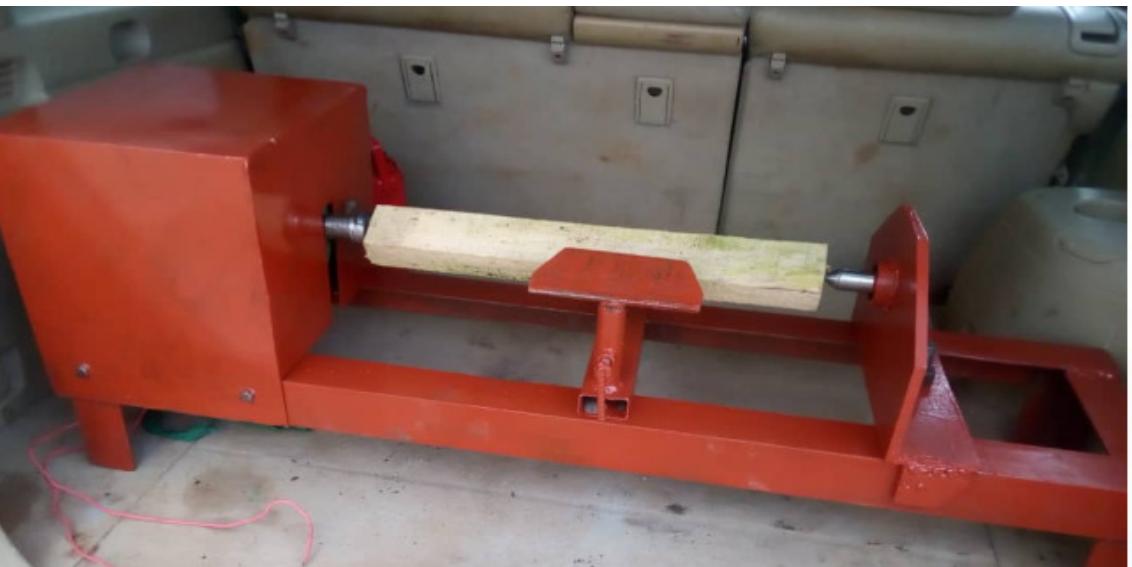 Loaded mini laboratory wood lathe machine with wood for